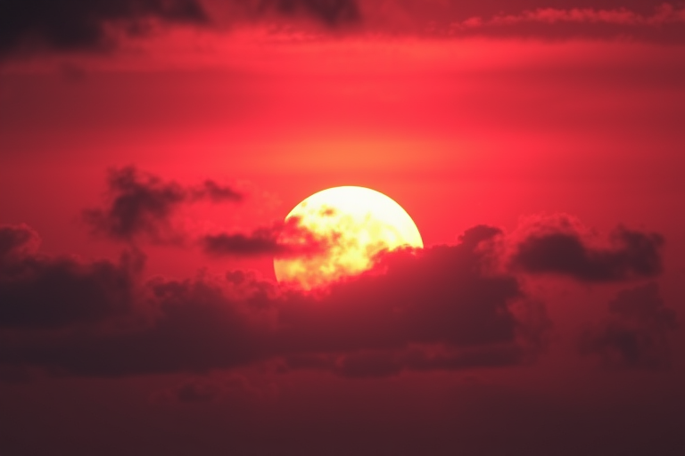 Vibrant Sunset Over the Horizon with Dramatic Red and Orange Skies