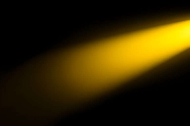 Bright Yellow Beam of Light Shining Through Darkness in a Dramatic Scene