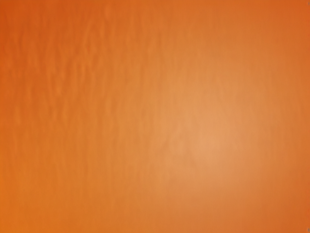 A Bright and Vibrant Orange Wall with a Subtle Textured Finish.