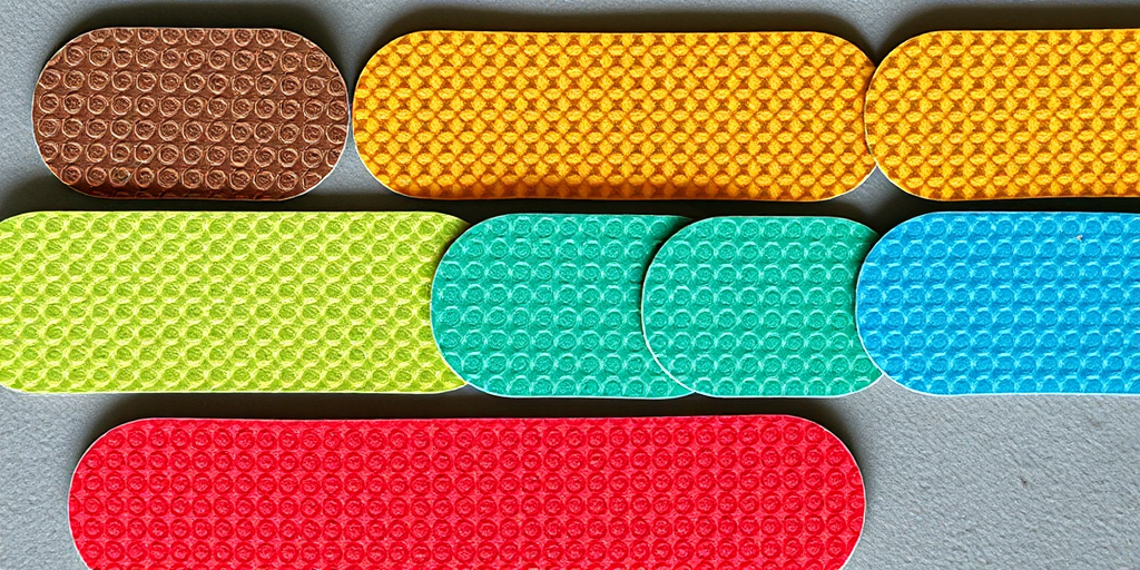Colorful collection of textured adhesive bandages arranged in a pattern.