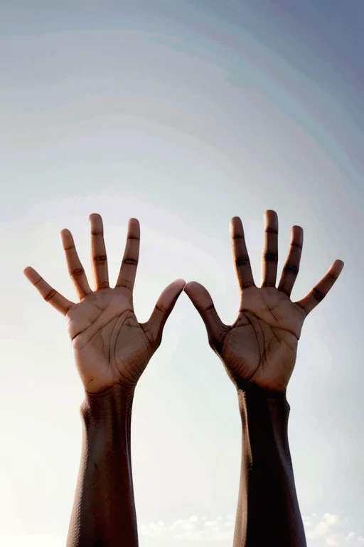 Two Hands Raised Towards the Sky, Symbolizing Hope and Unity.