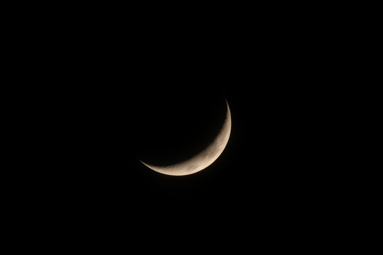 The Serene Beauty of a Crescent Moon Illuminating the Night Sky