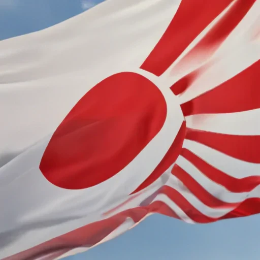 Vibrant Japanese Flag Waving Proudly Against a Clear Blue Sky