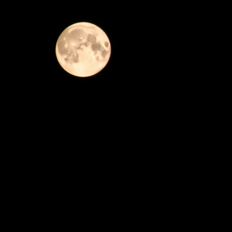 A Beautiful Full Moon Illuminating the Night Sky with Soft Glow.