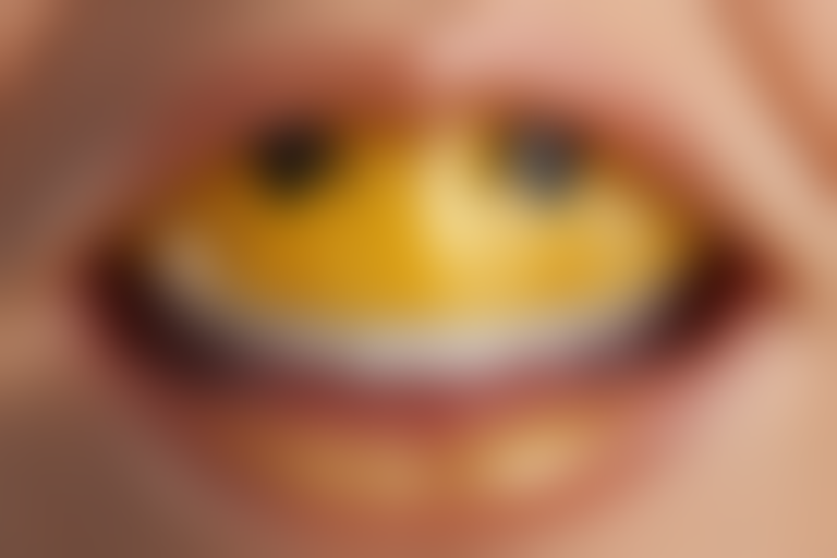 A Close-Up of a Brightly Colored Smiley Face Inside an Open Mouth.