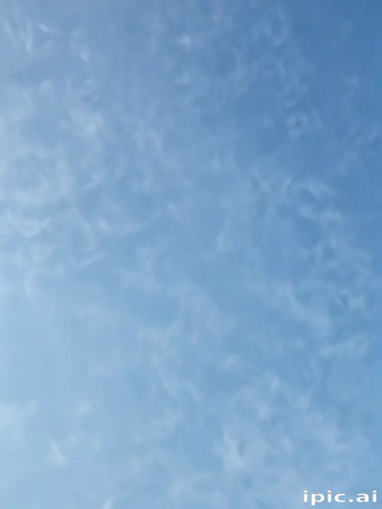 Vast Blue Sky with Wispy Clouds Creating a Serene Atmosphere