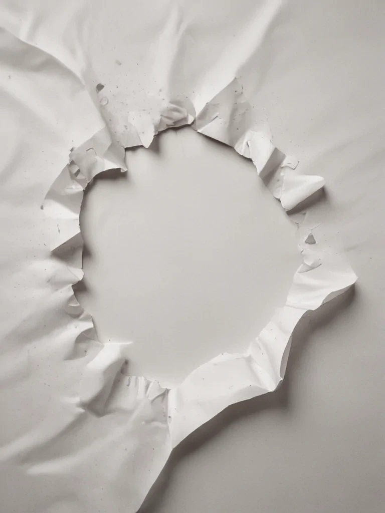 Textured Paper Torn Open to Reveal a Blank White Background