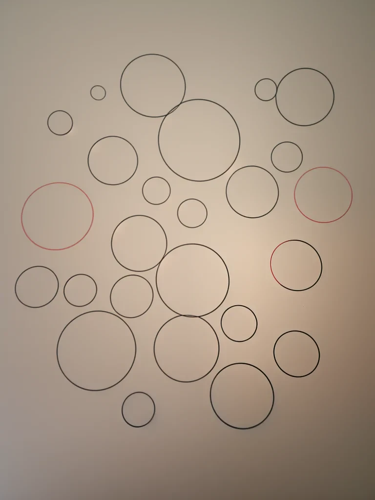 Abstract Composition of Varying Sized Circles in Black and Red