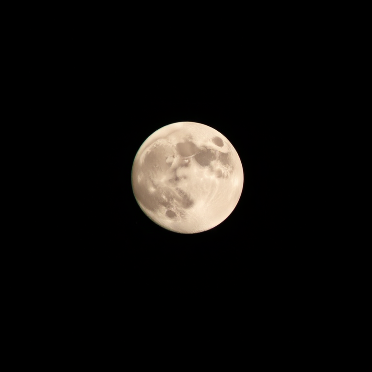 A Stunning Close-Up View of the Full Moon Against a Dark Sky.
