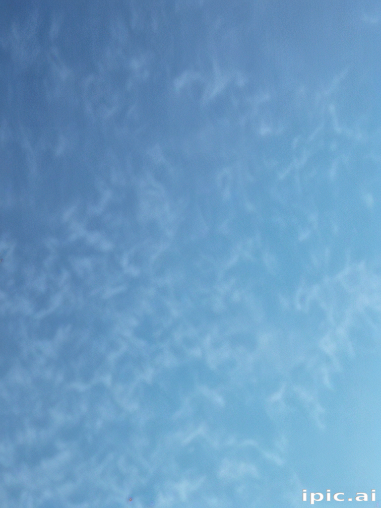 Vast Sky Displaying Soft, Wispy Clouds Against a Bright Blue Background